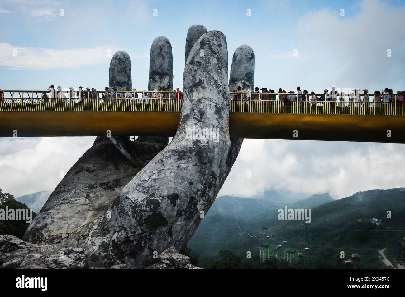 View of the famous Golden Bridge is lifted by two giant hands in the ...