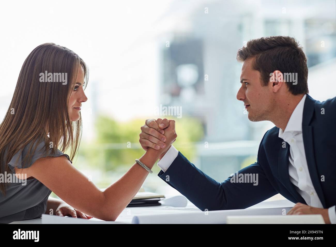 Office, business people and arm wrestle for challenge, competition and ...