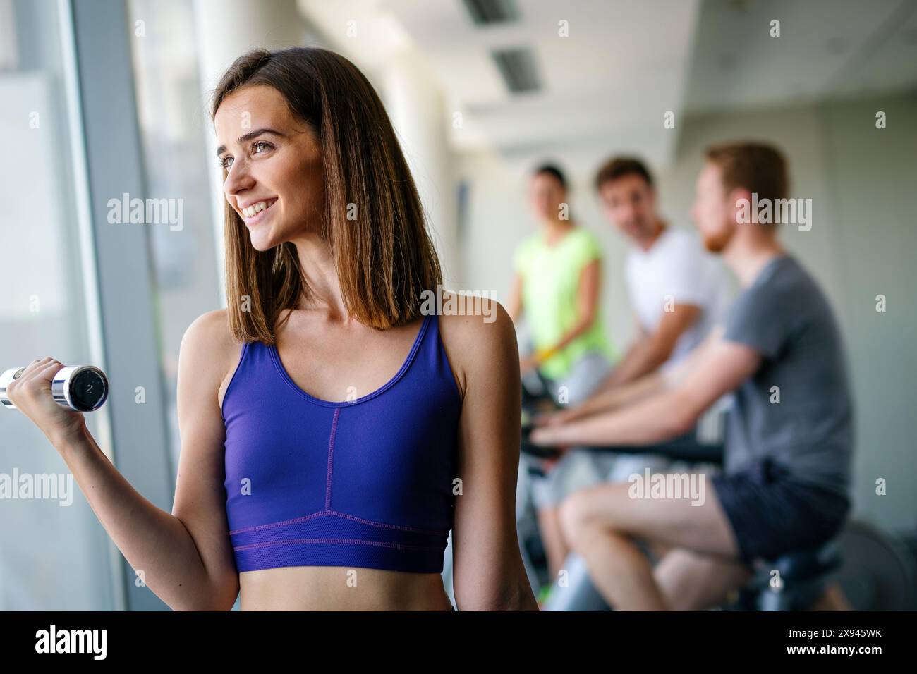 Fitness woman. Fit fitness girl smiling happy lifting weights looking ...