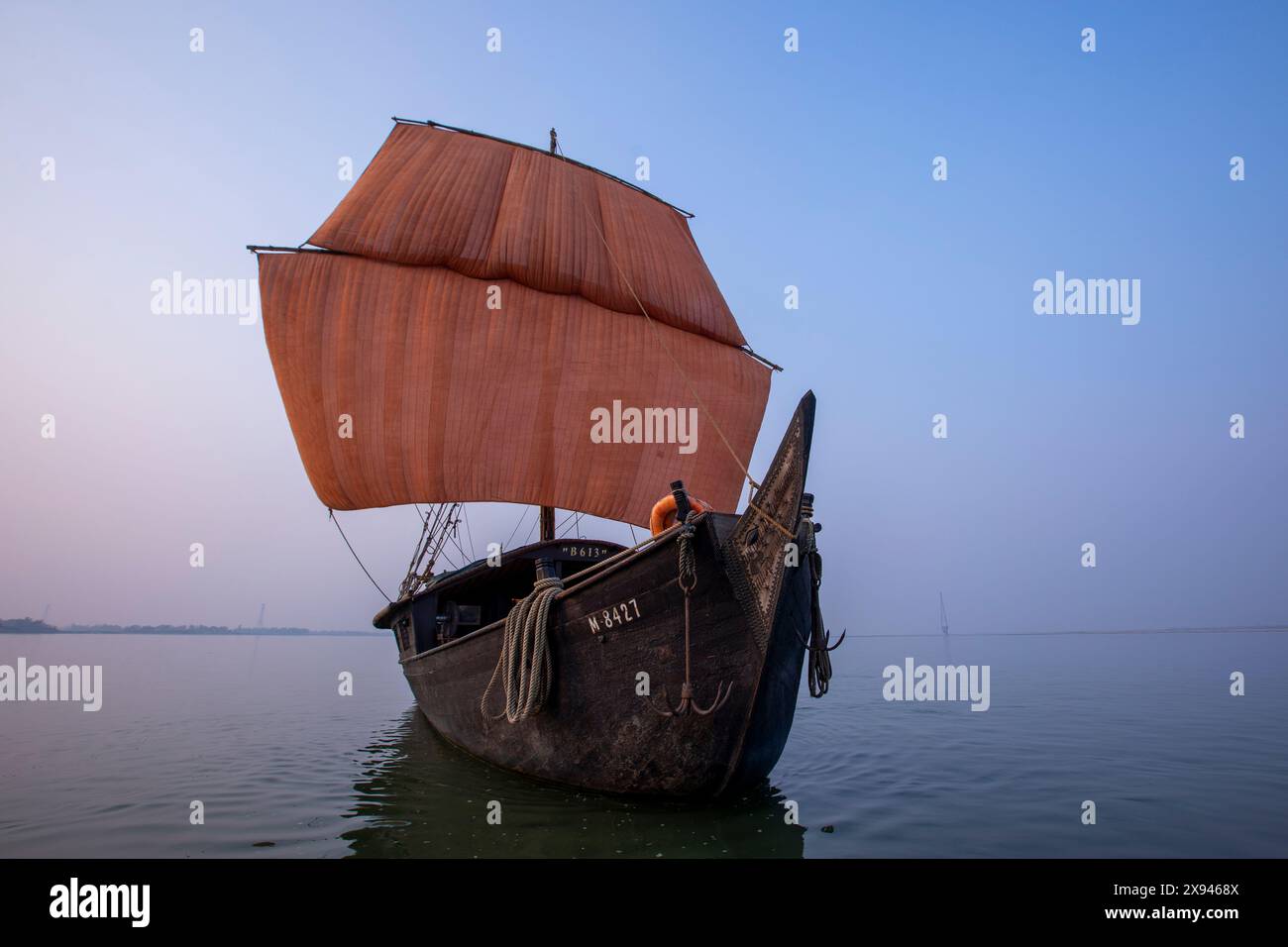A traditional sailing wooden boat on the Jamuna River, Manikganj ...