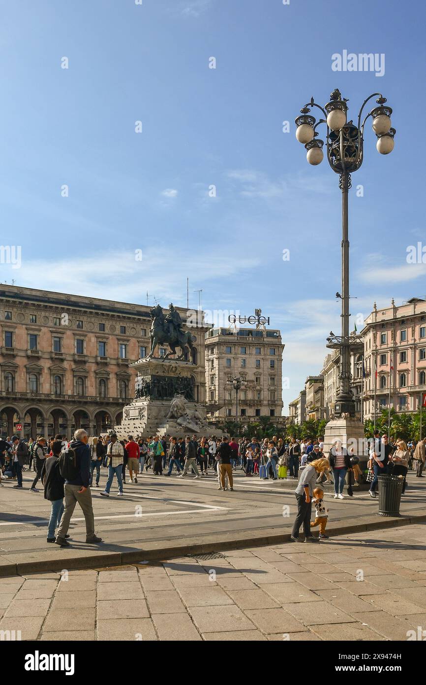 People walking in Piazza del Duomo, under the statue of King Victor ...