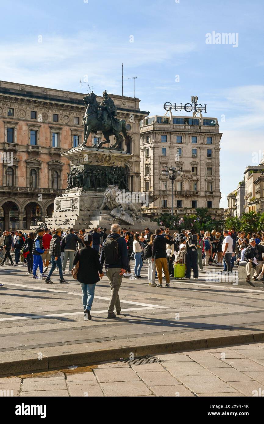 People walking in Piazza del Duomo, under the statue of King Victor ...