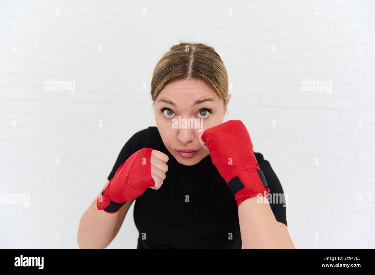 Strong and beautiful European athletic woman, boxer fighter with ...
