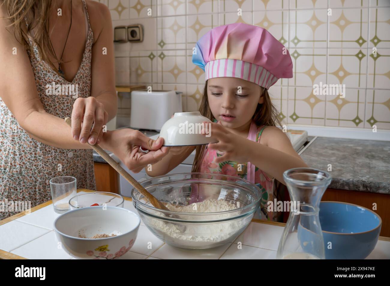 a girl dressed as a cook enjoying an afternoon of cooking with her ...