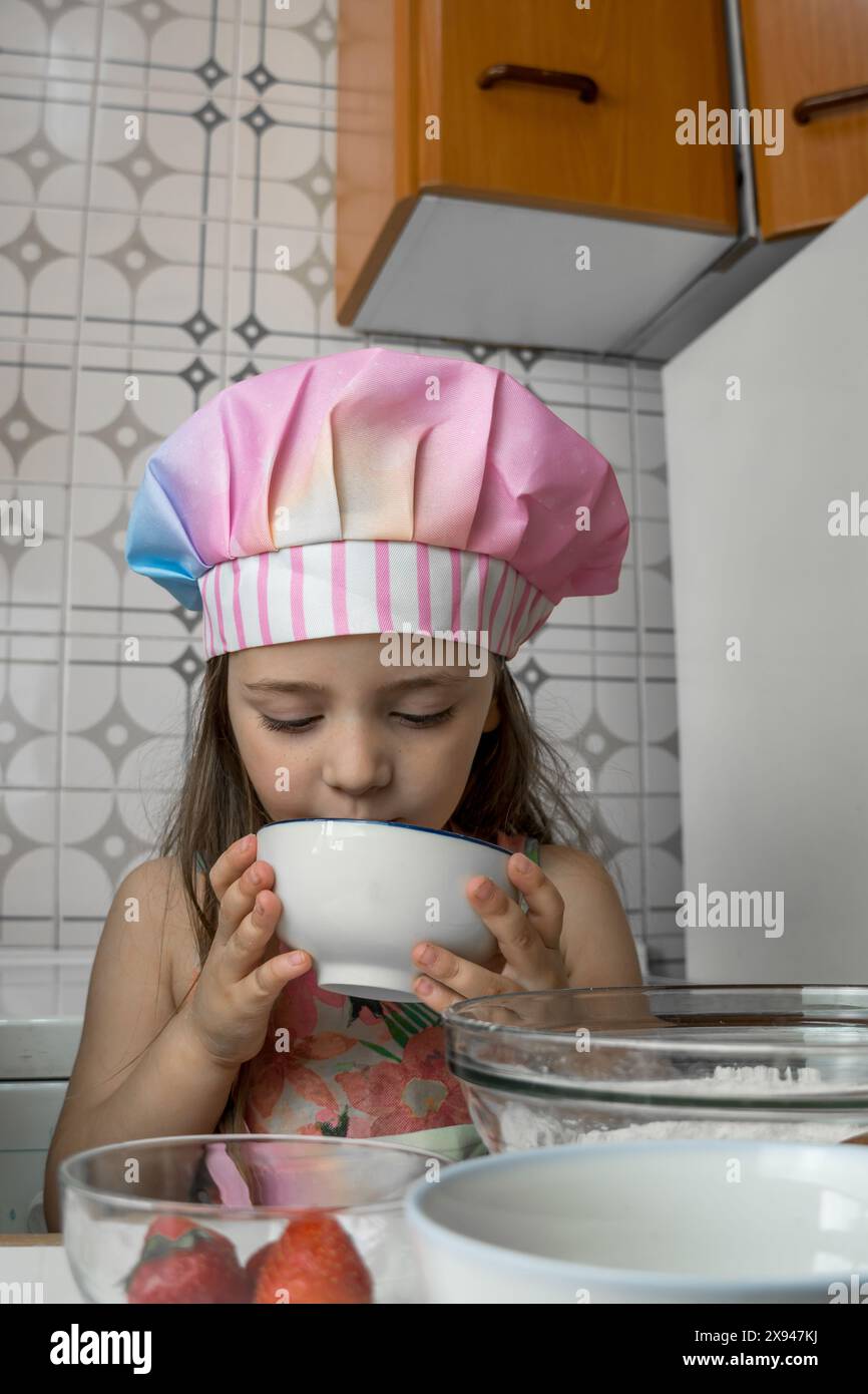 a girl dressed as a cook enjoying an afternoon of cooking with her ...