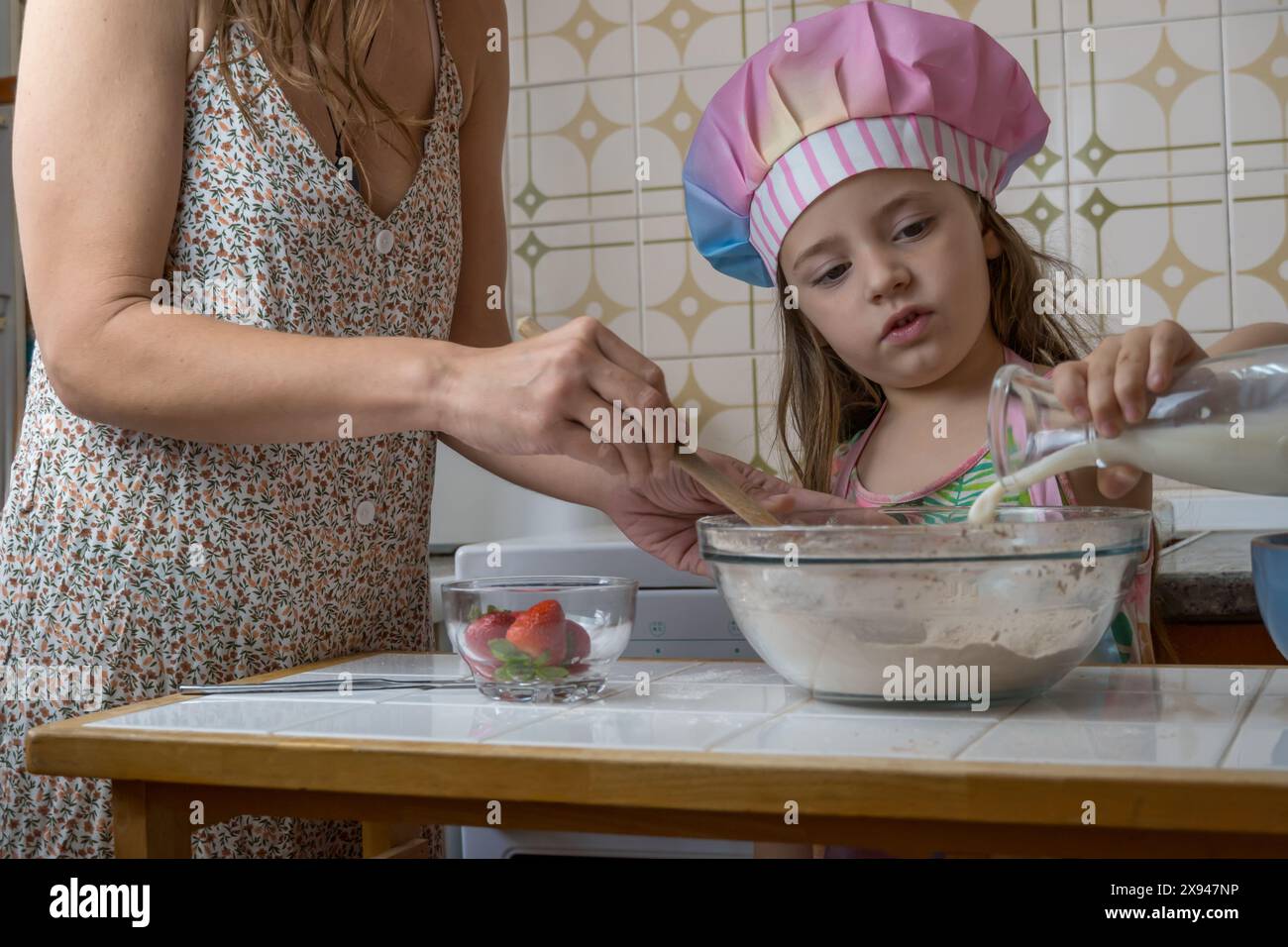 a girl dressed as a cook enjoying an afternoon of cooking with her ...