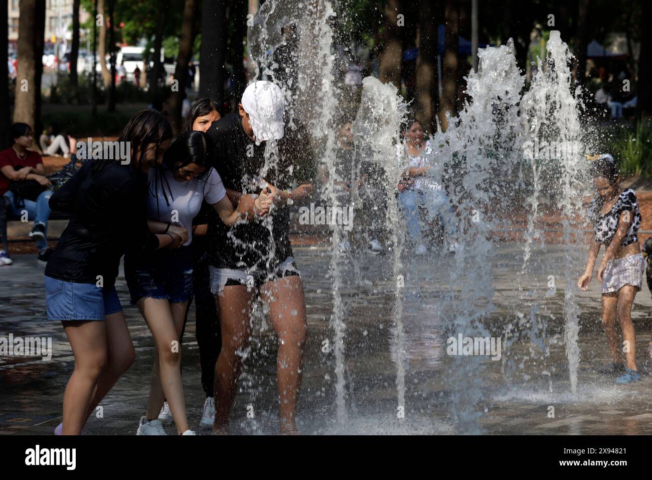 Non Exclusive: Youths cool off by getting wet in a fountain at the ...