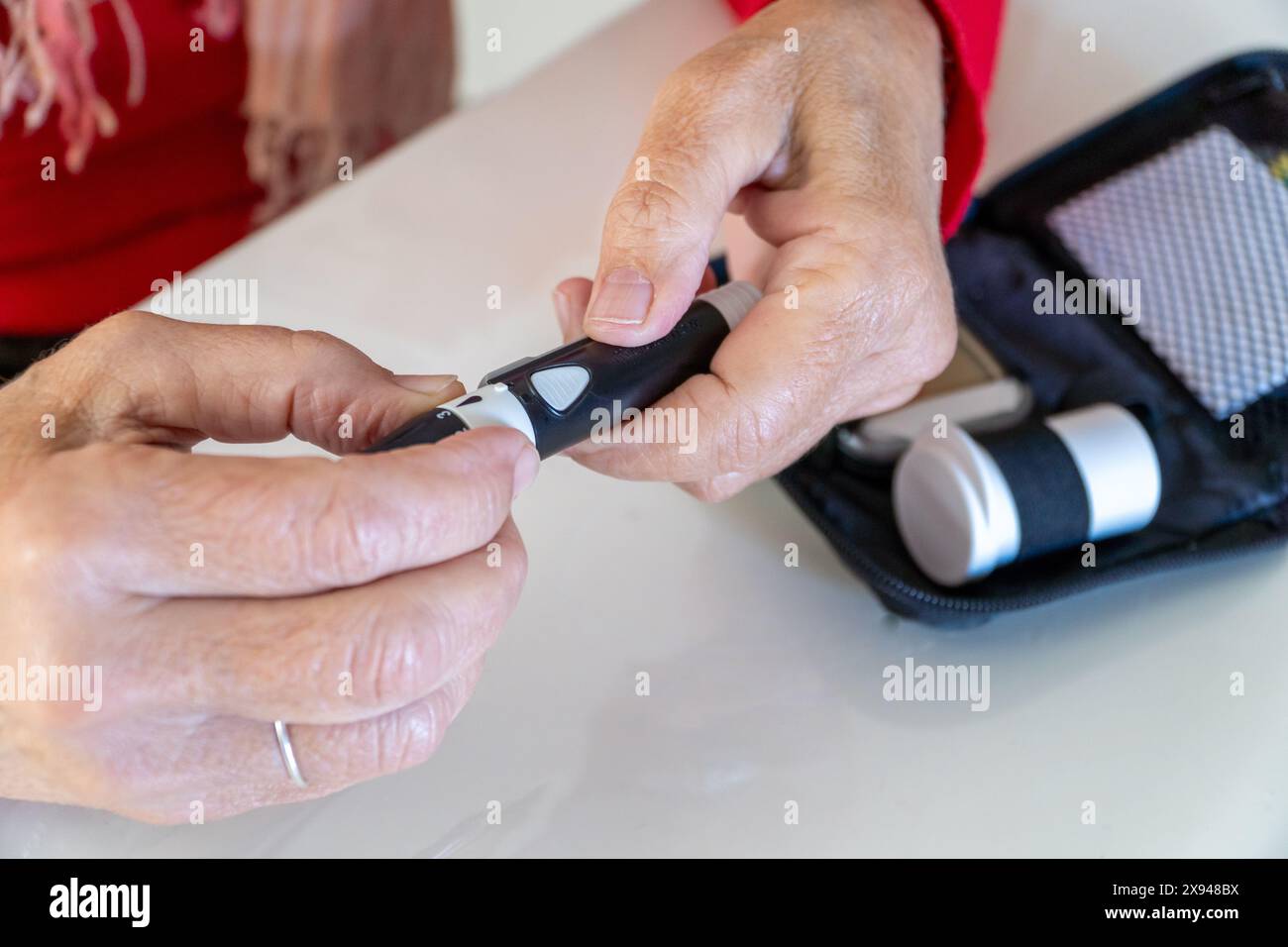 Patient with diabetes choosing the puncture depth of the lancing stick ...