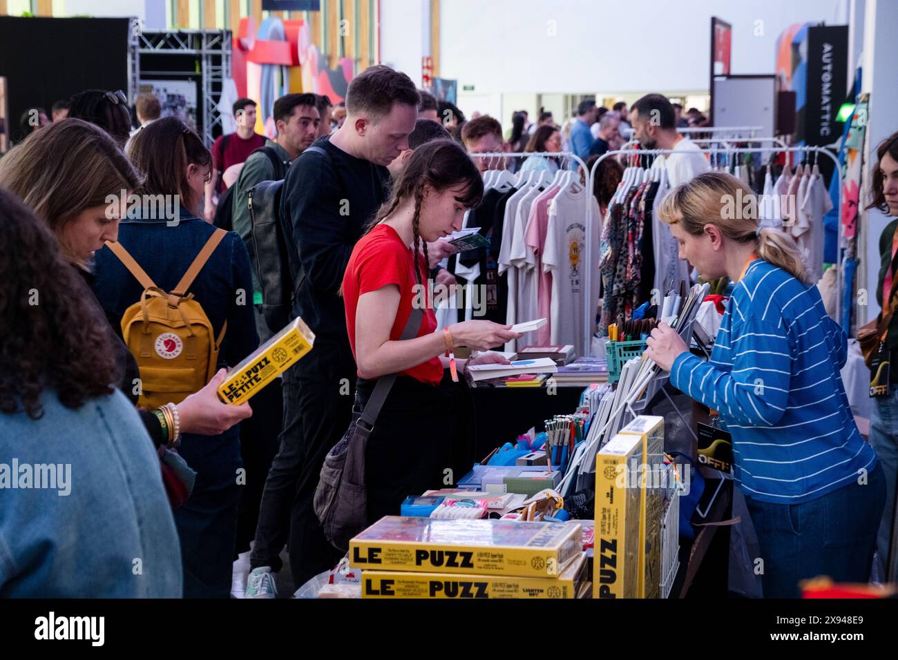 Attendees mingle, walk and check out the offers in the retail market ...