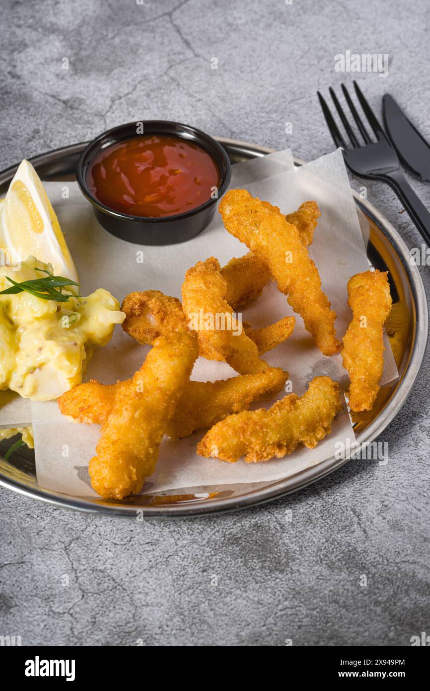 Deep fried shrimp tempura with potato salad on a metal plate Stock ...
