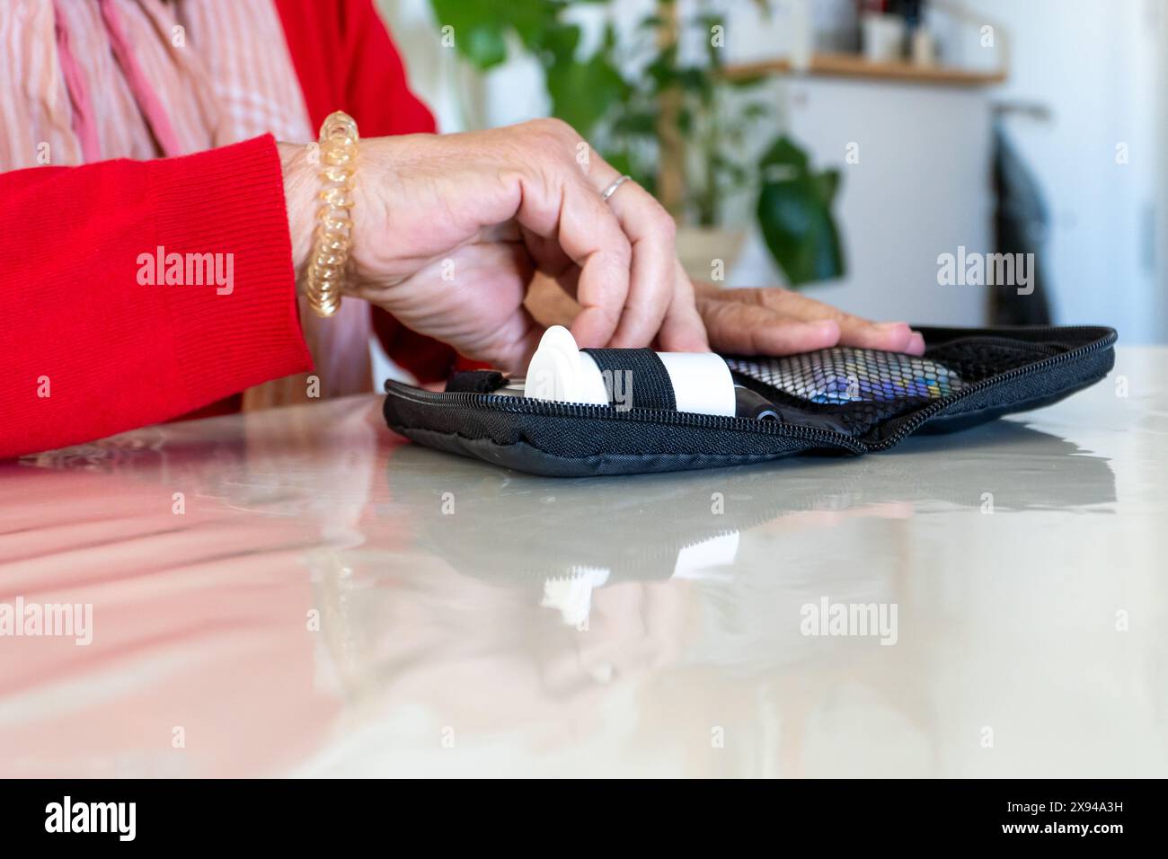 Patient with diabetes handling a domestic kit to check sugar on blood ...