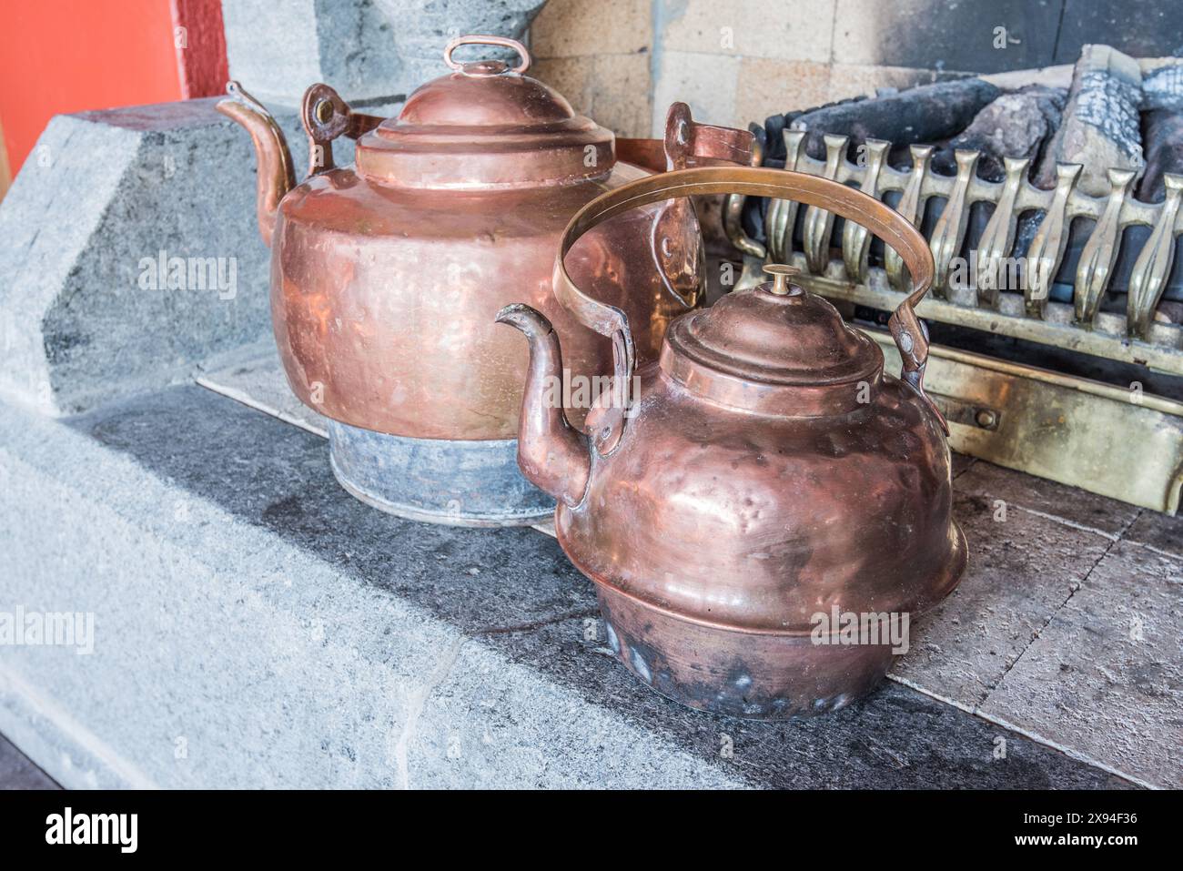 Two superb, old copper kettles on a magnificent fireplace at the ...