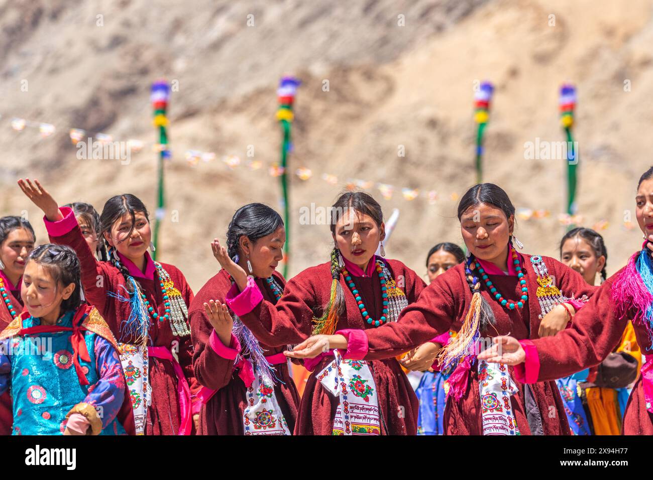 A group of young Buddhist girls performing traditional dance sequence ...
