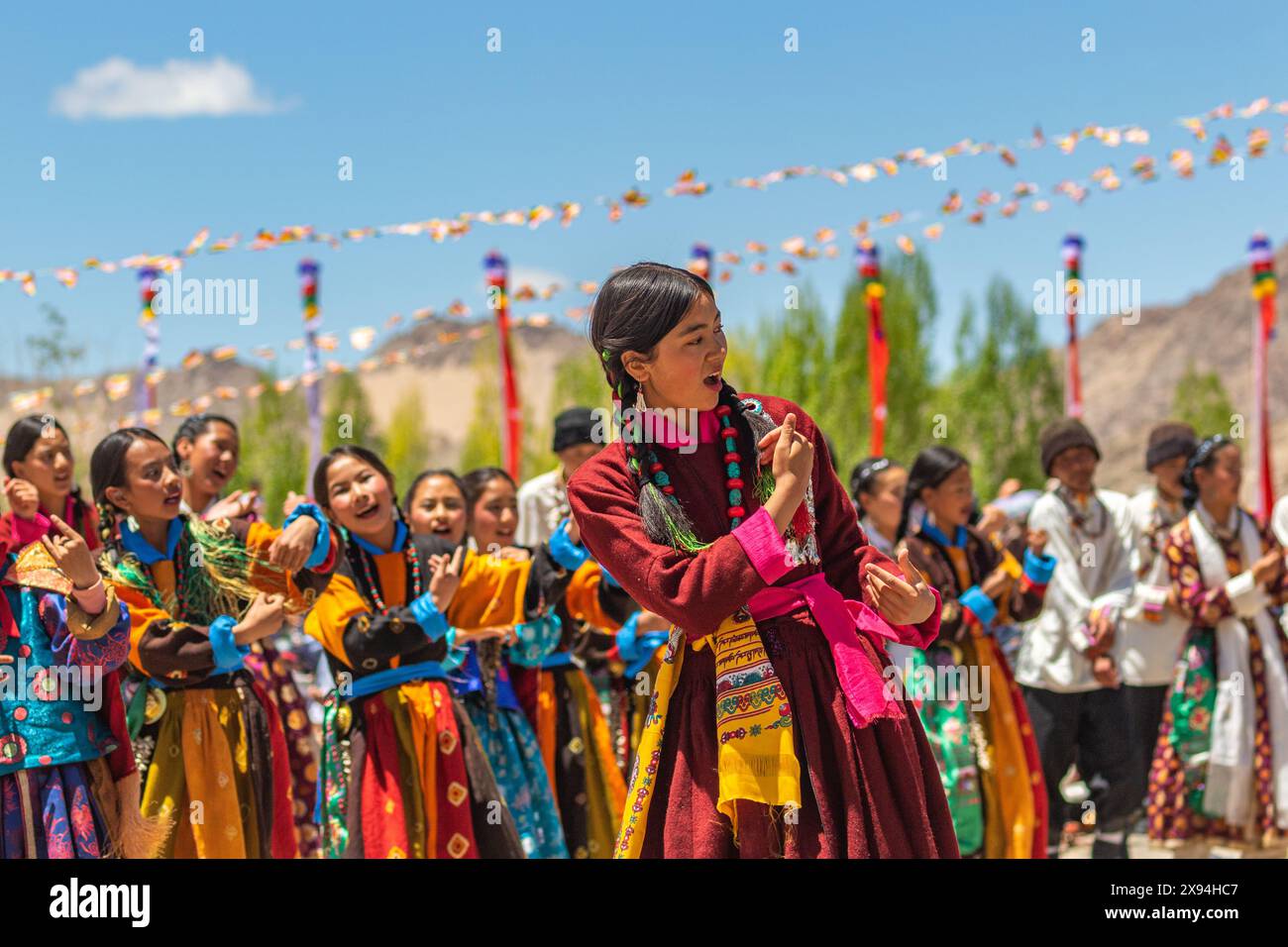 A group of young Buddhist girls performing traditional dance sequence ...