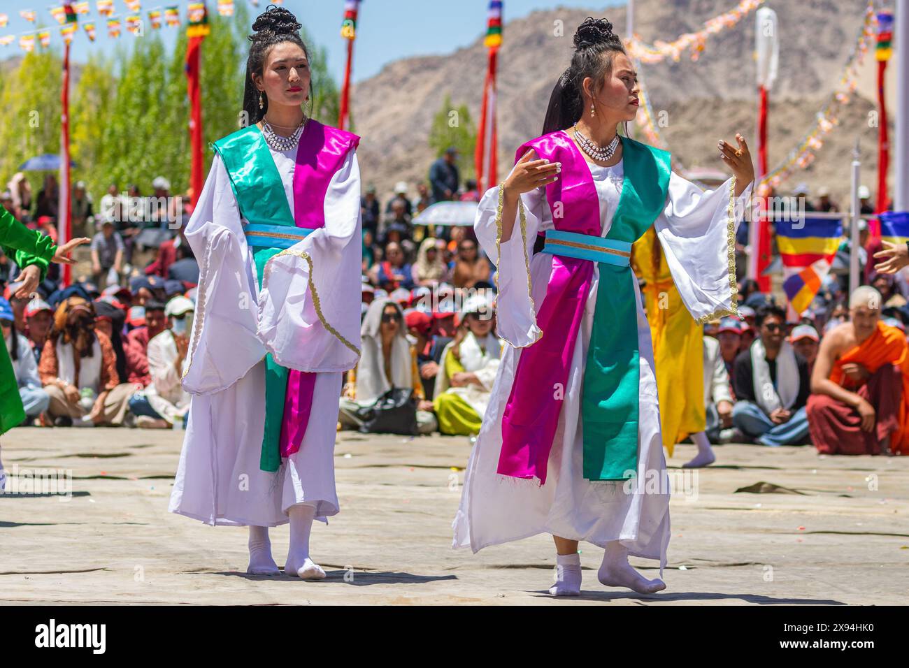 A group of young Buddhist girls performing traditional dance sequence ...