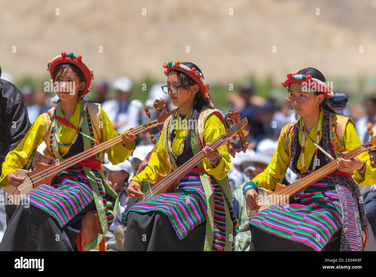 Portrait of young Ladakhi girls wearing traditional attire and playing ...