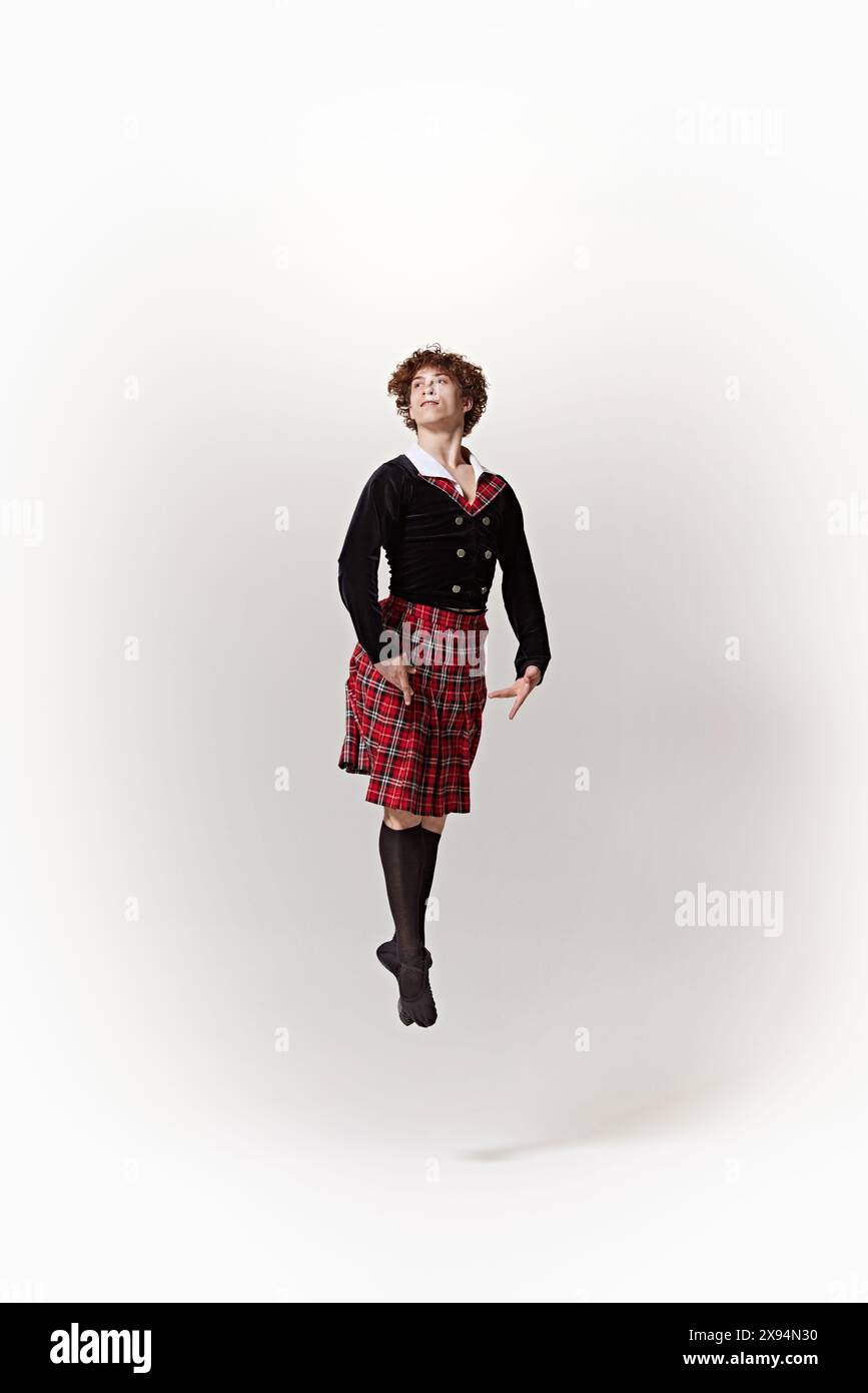 Young man, ballet dancer in traditional Scottish outfit strikes ...