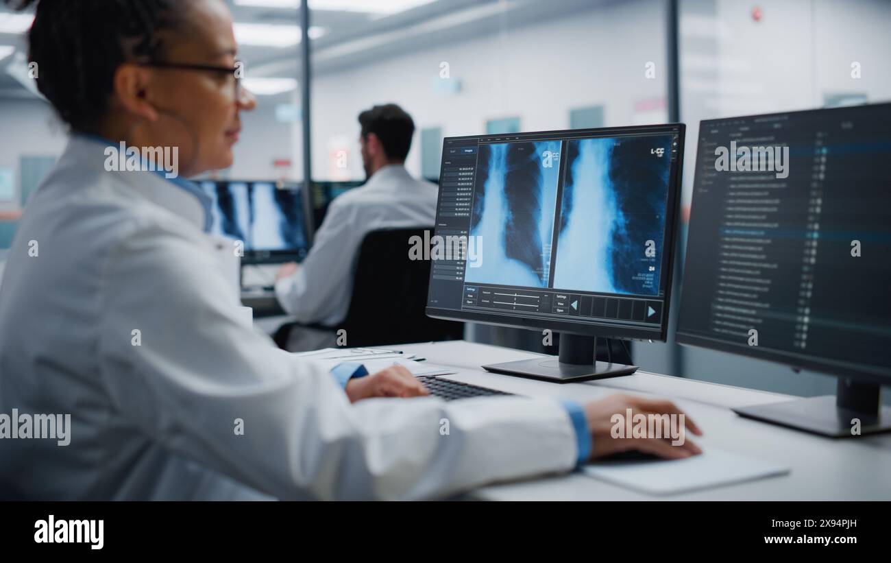 Modern Hospital Laboratory: Black Female Medical Doctor is Working on ...