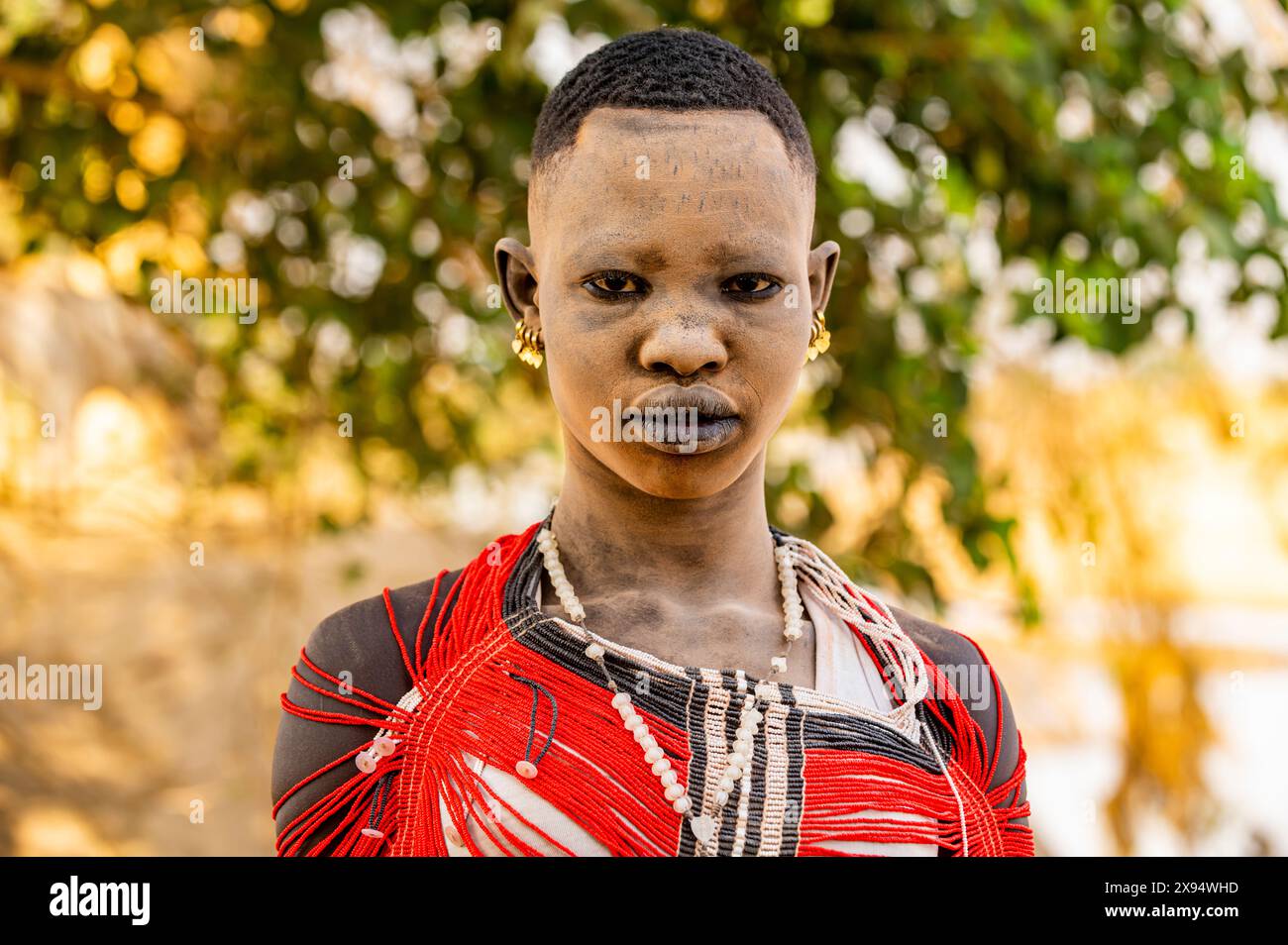 Mundari woman in a traditional dress with ash on face, Mundari tribe ...