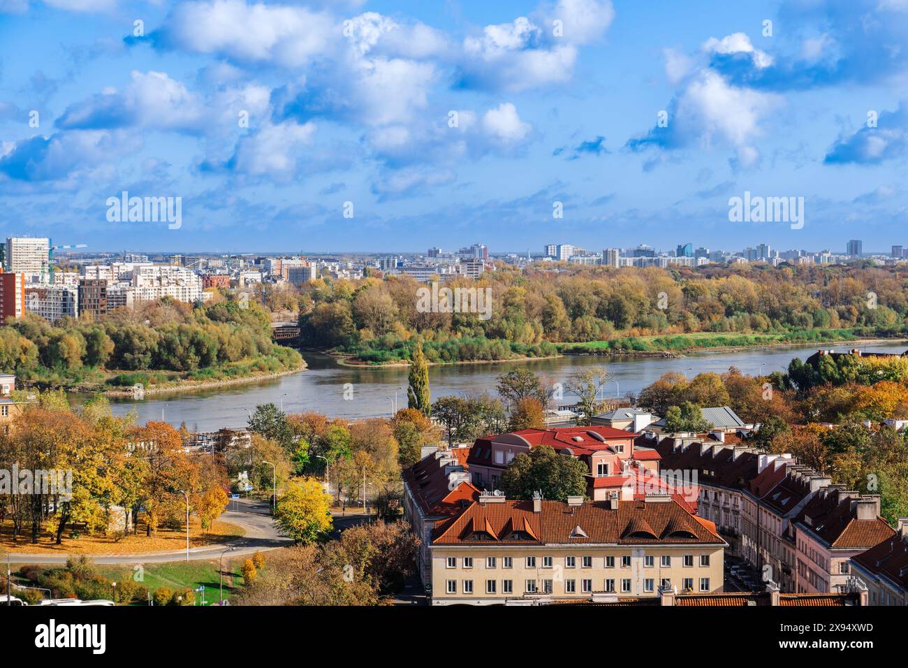 View of city skyline with houses and skyscrapers under a blue sky with ...