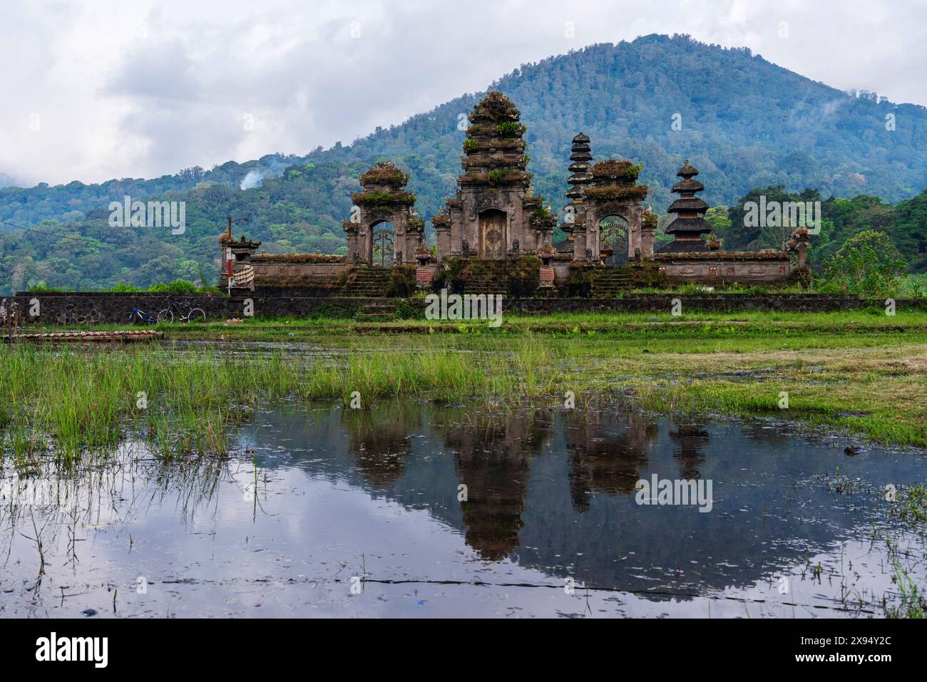 Reflection of the temple Ulun Danu Tamblingan in the water of the lake ...