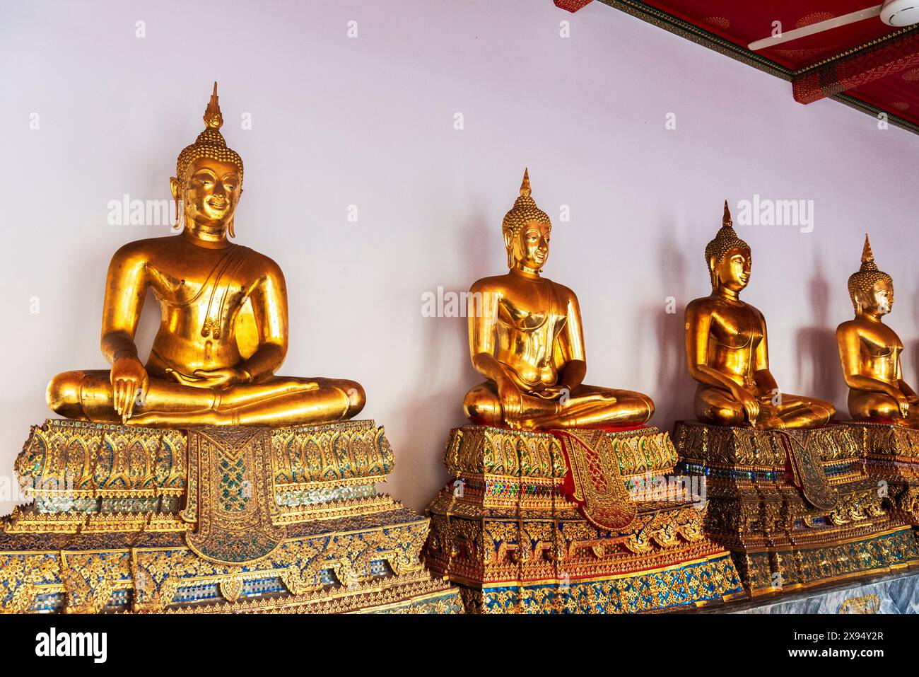 Rows of golden Buddha statues in a temple of Wat Pho, Bangkok, Thailand ...