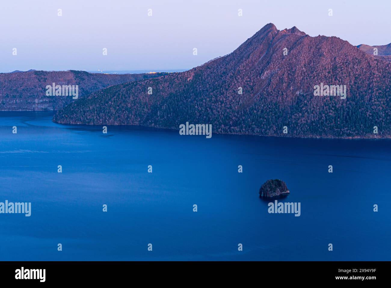 Calm purple evening light, of blue hour, deep blue Lake Mashu in a ...