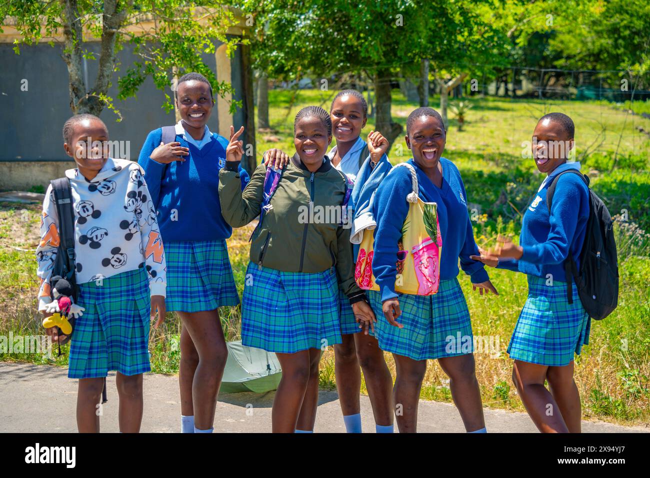 View of school girls smiling for camera in traditional Zulu village ...