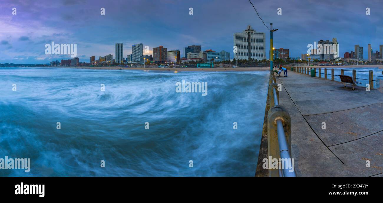View of beaches, promenade and hotels from New Pier at dusk, Durban ...