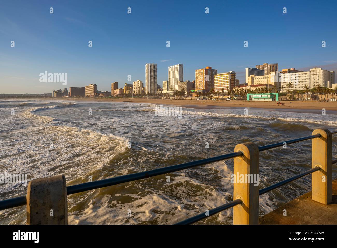 View of promenade, beach and hotels from pier in Indian Ocean at ...