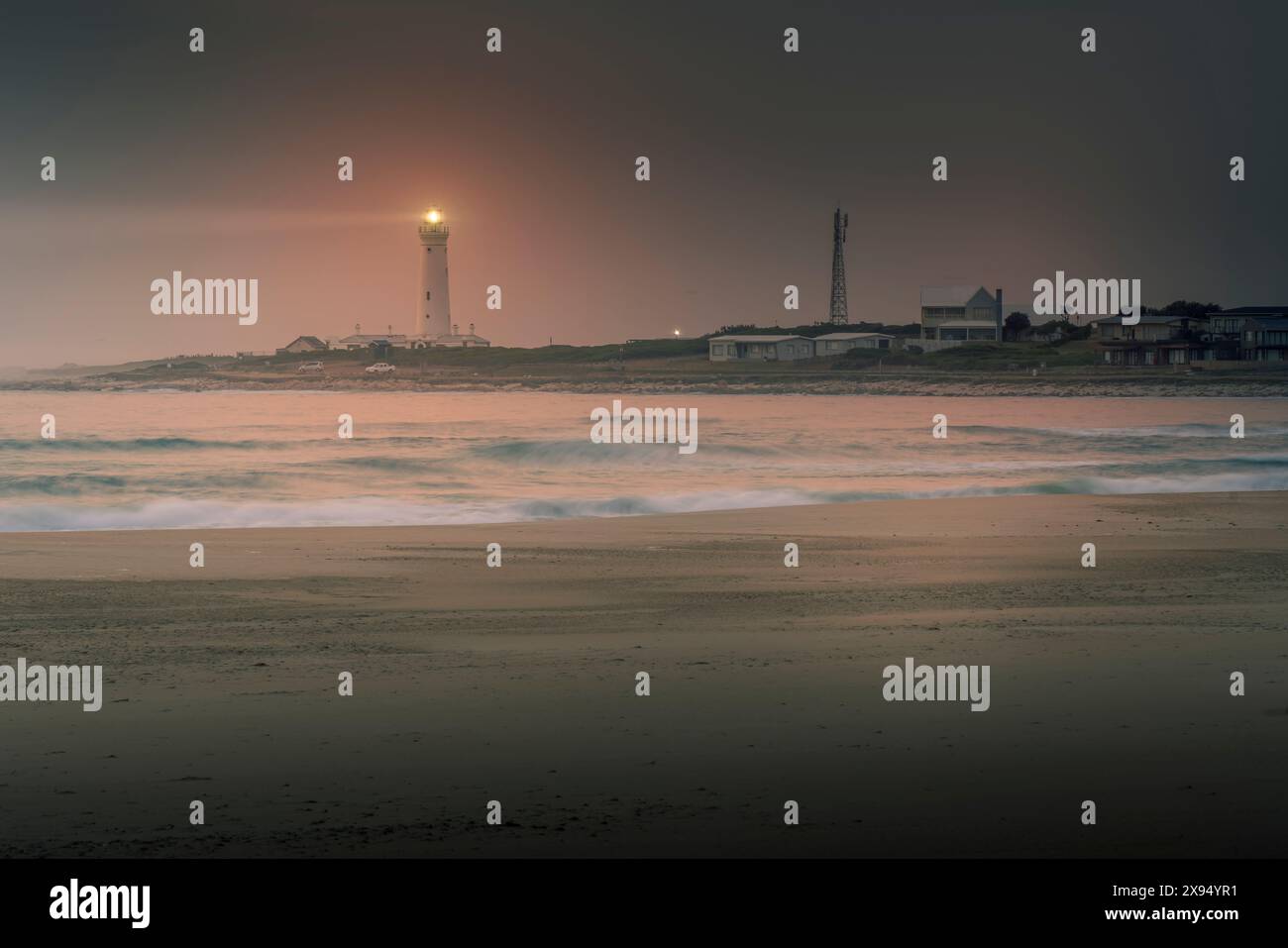 View of beach and Seal Point Lighthouse at sunrise, Cape St. Francis ...