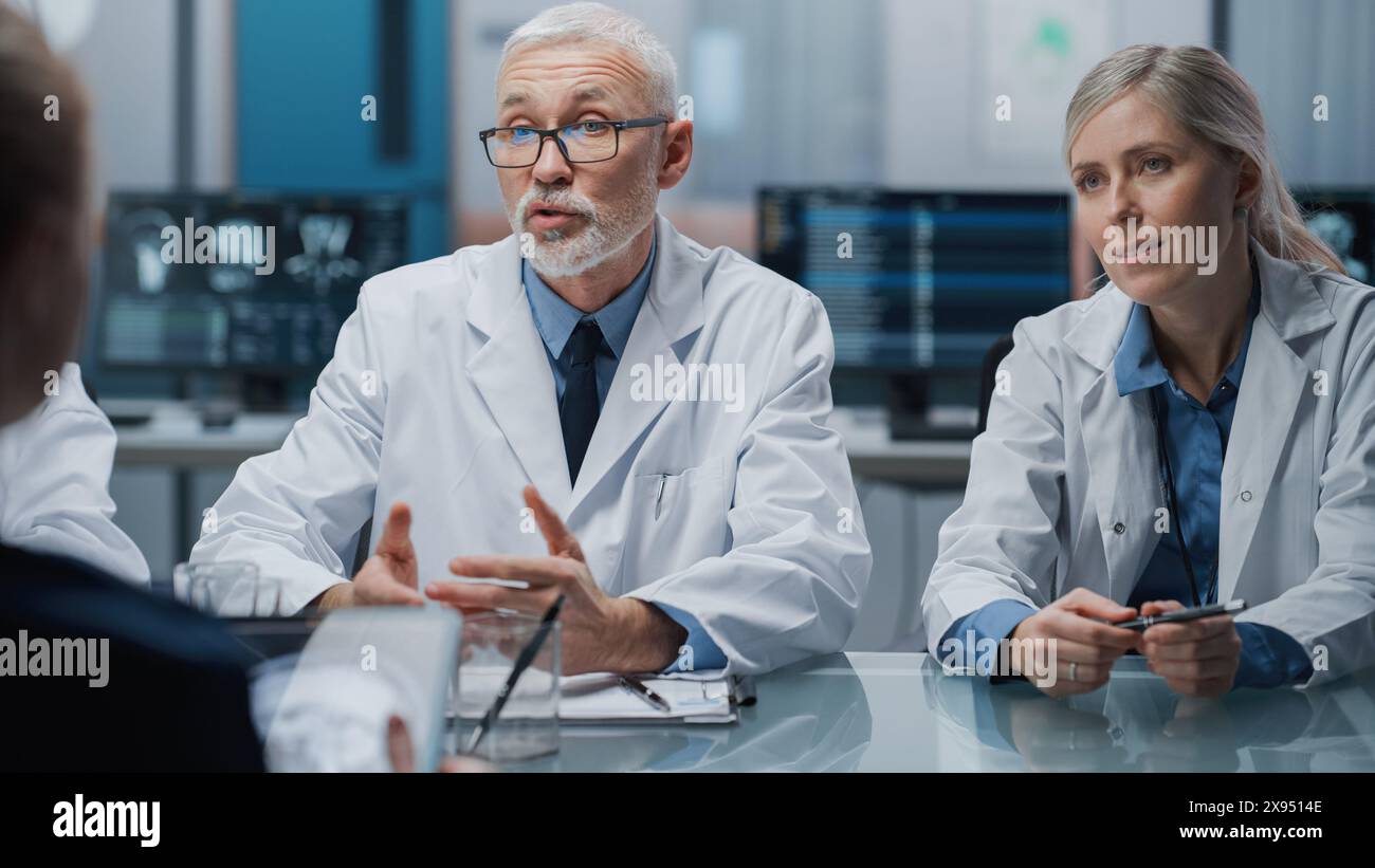 Hospital Conference Meeting Room: Senior Neuroscientist Uses Tablet ...