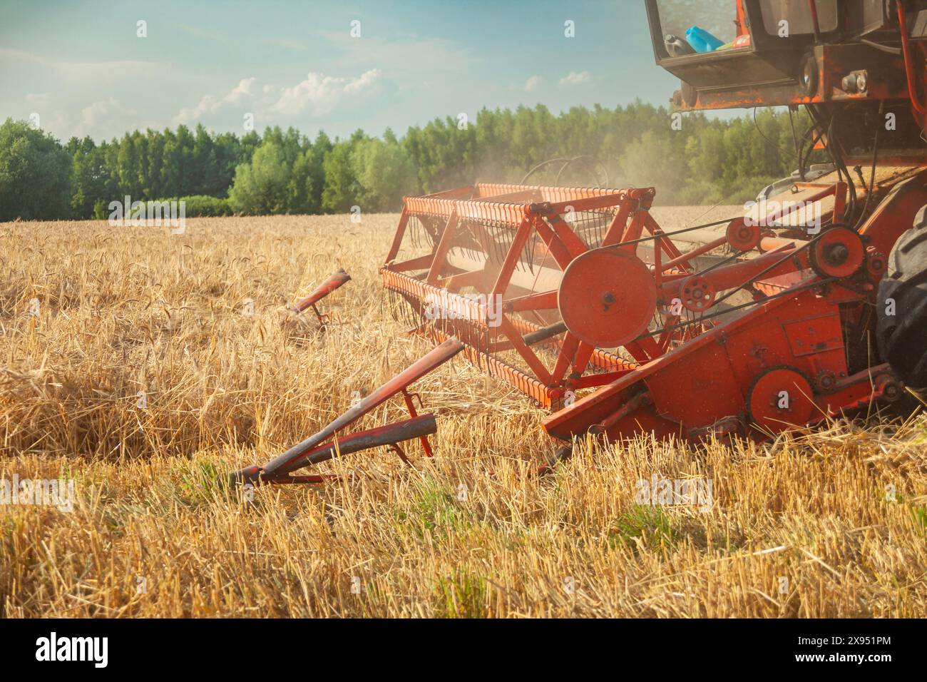 A combine harvester mowing low, poor grain yields, summer view Stock ...