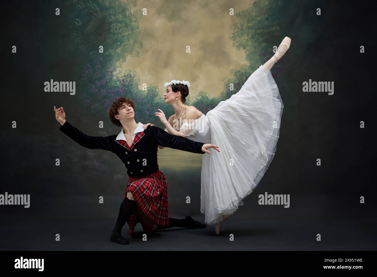 Ballerina in arabesque pose touching shoulder of her beloved partner ...