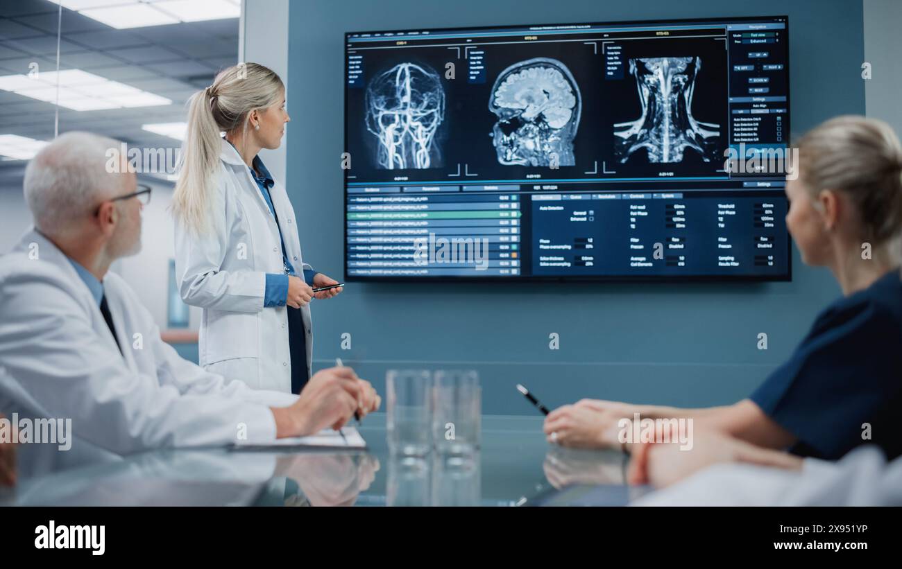 Hospital Conference Meeting Room: Female Neurologist Shows MRI Scan Brain Images on TV Screen ...