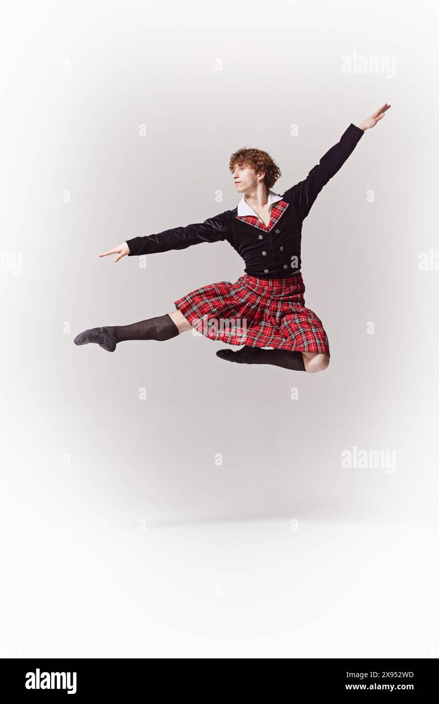 Young man, ballet dancer in traditional Scottish outfit strikes ...