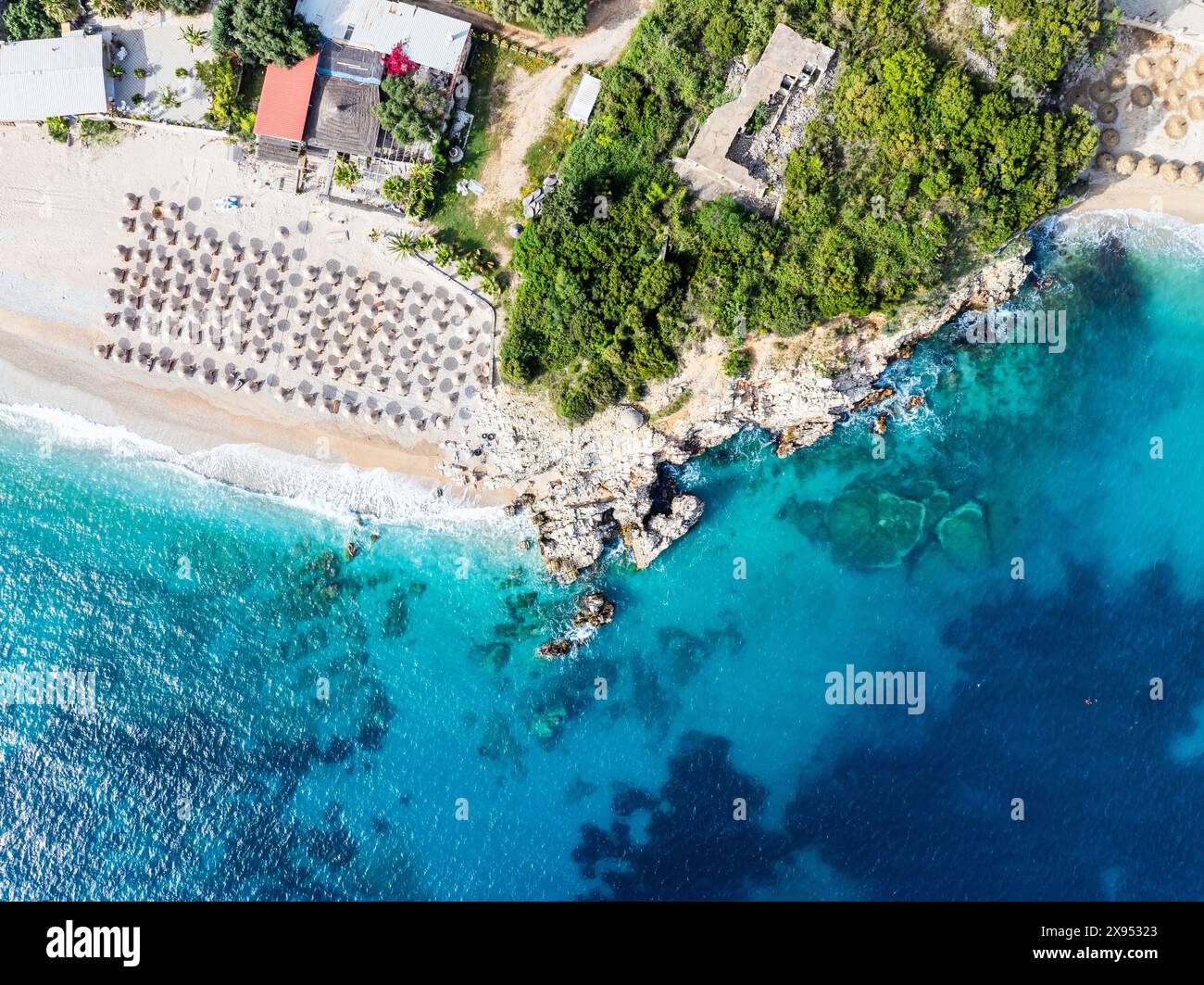 Top Down over Umbrellas and Beach in Himare from a drone, Albanian ...