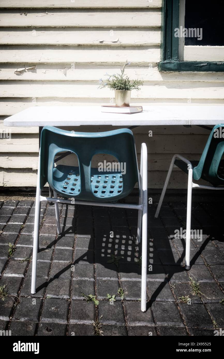 Plastic chairs and a temporary table in an outside cafe a a vintage ...