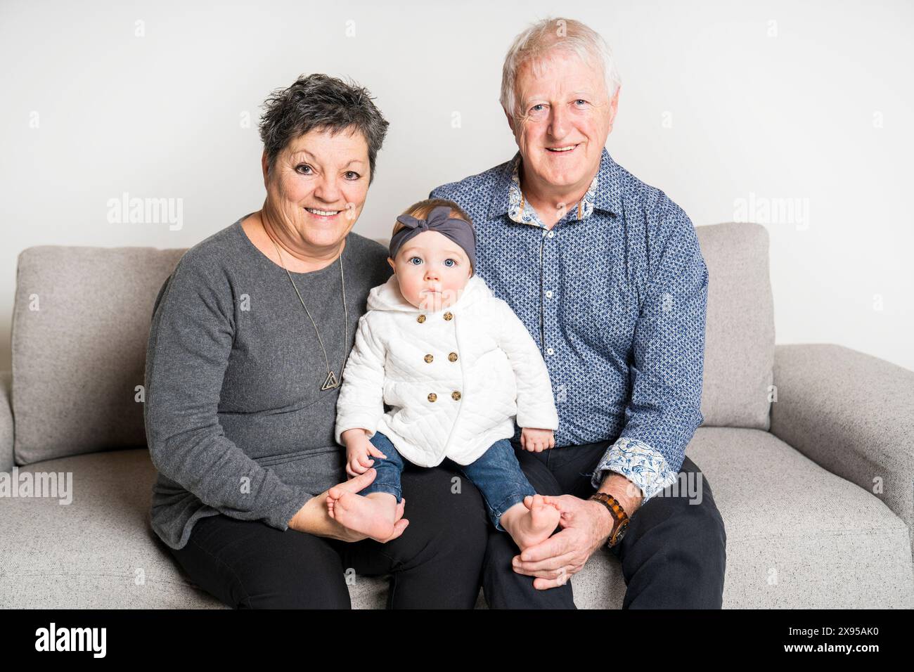 Senior couple with baby granddaughter Stock Photo - Alamy