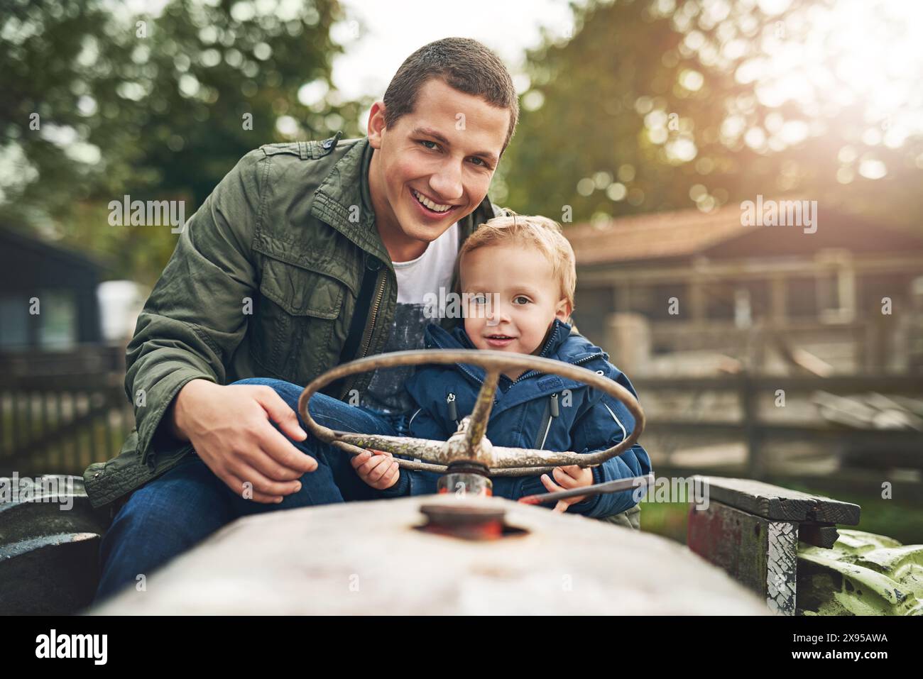 Father, child and tractor for learning to drive on farm for growth and ...