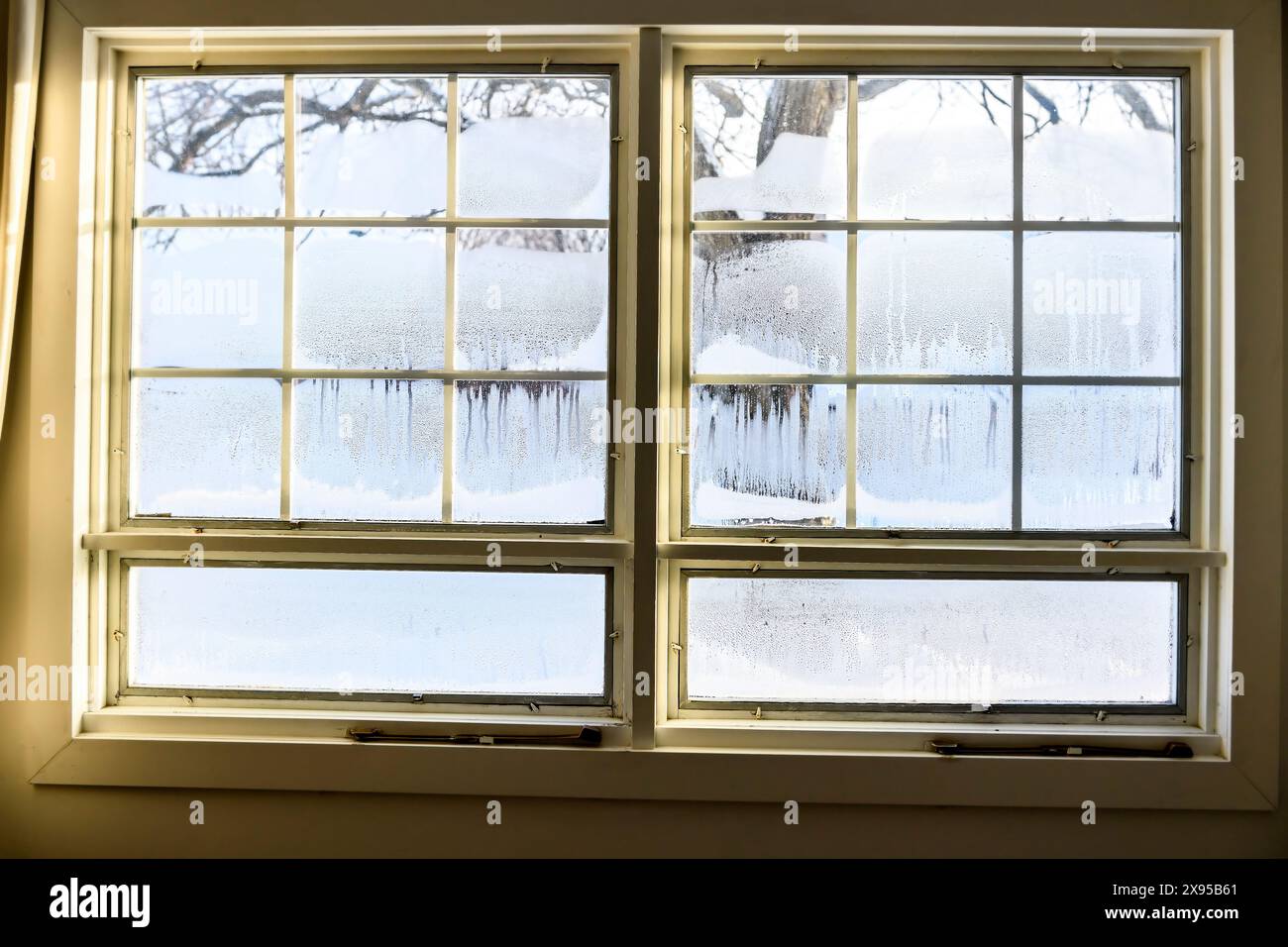 Drops of condensation on the metal-plastic window. Fragment of a ...