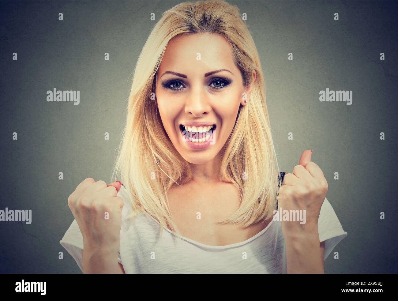 Photo of ecstatic woman shouting loud yeah with fists up Stock Photo ...