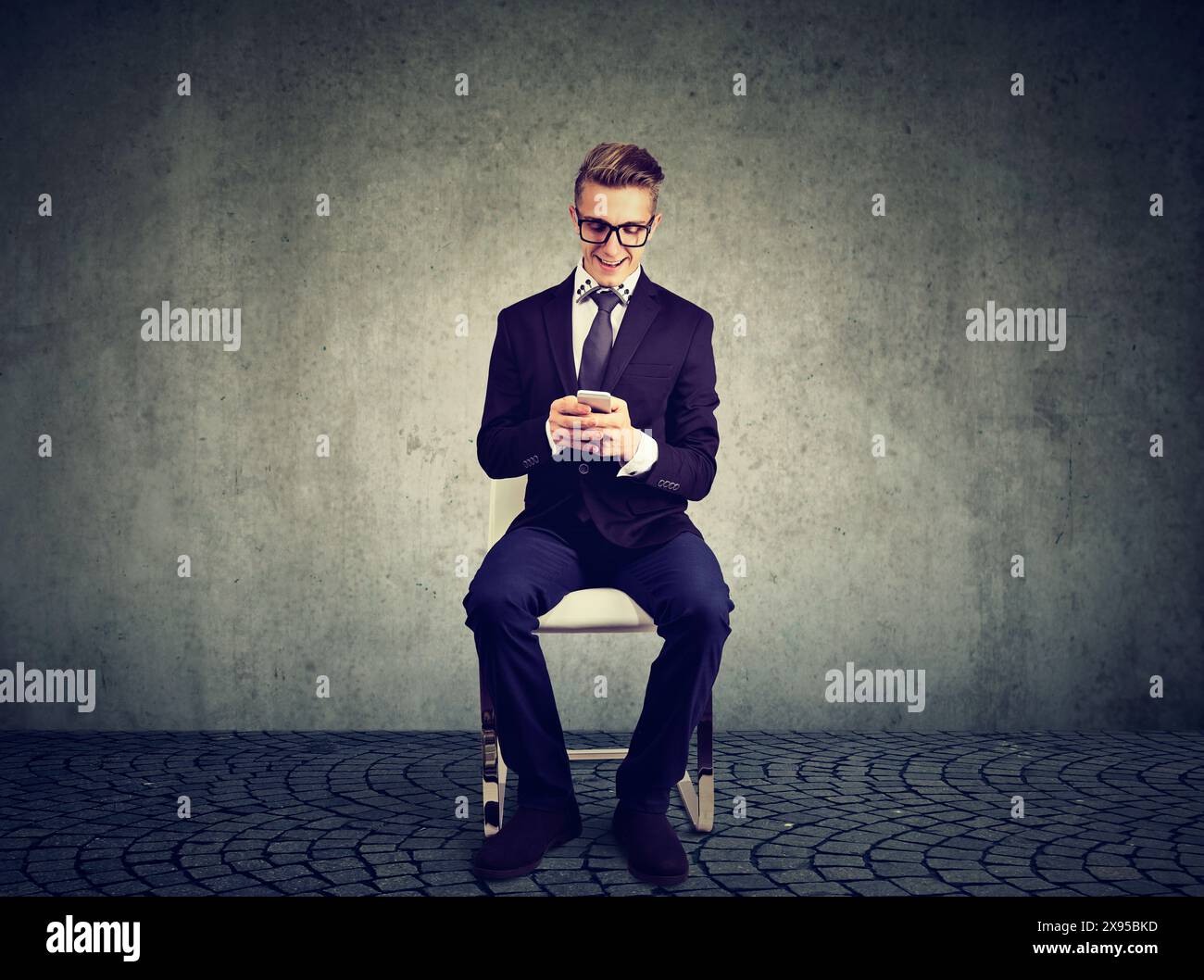 Manager uses smartphone sitting hi-res stock photography and images - Alamy