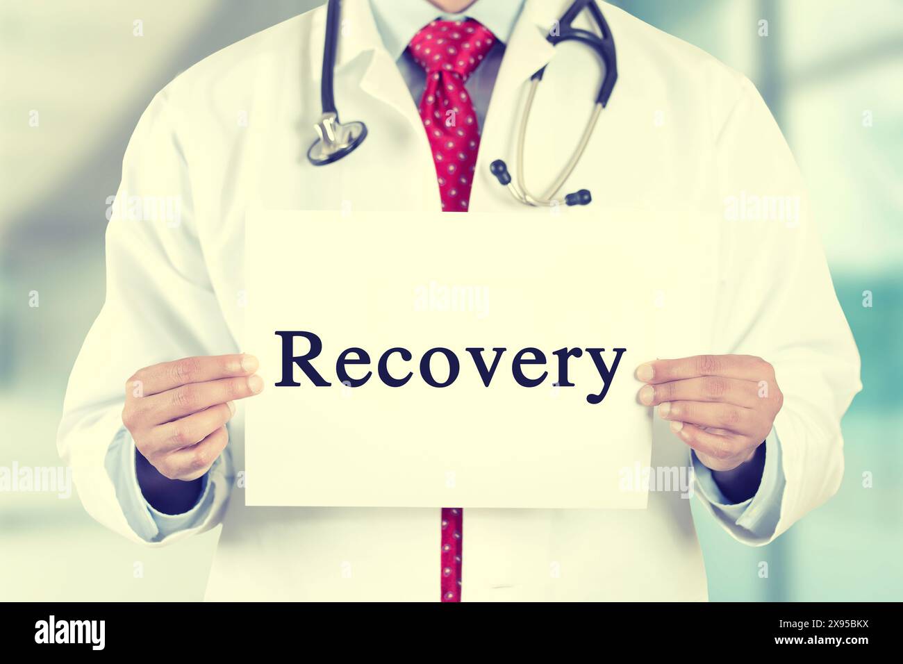 Closeup of doctor hands holding white card with recovery text message ...