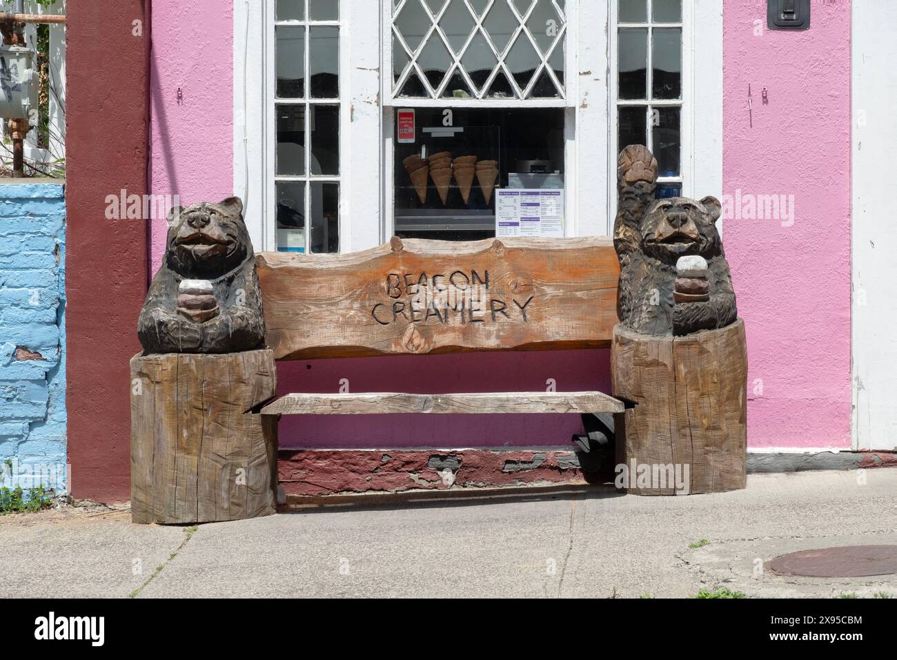 A quirky hand carved wooden benck with ice cream eating bears. Outside ...
