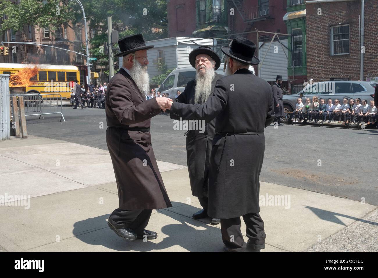 3 rabbi teachers dance & celebrate Lag B'Omer in Brooklyn, NY. Note the ...