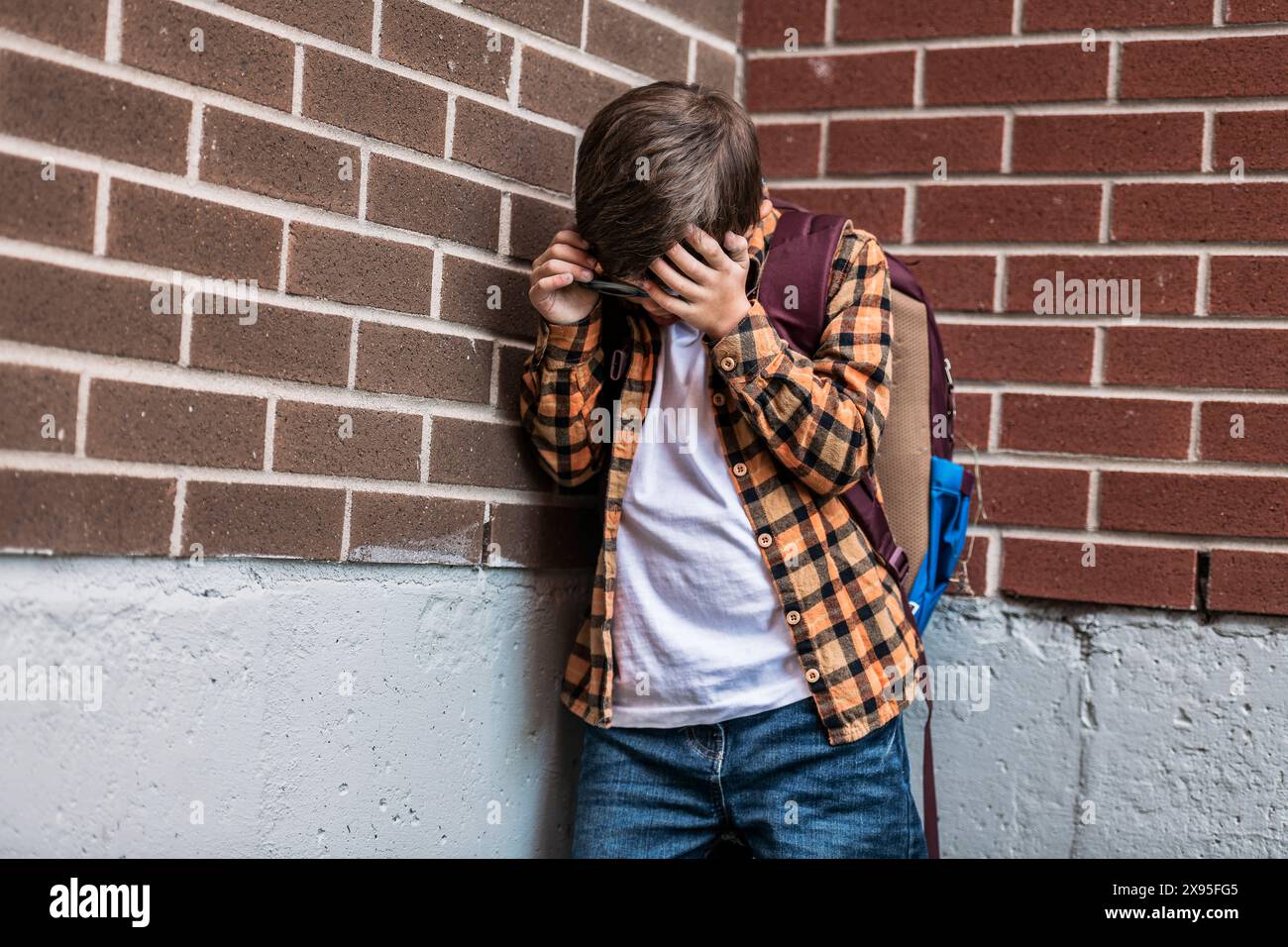 Sad child boy posing on the school playground Stock Photo - Alamy