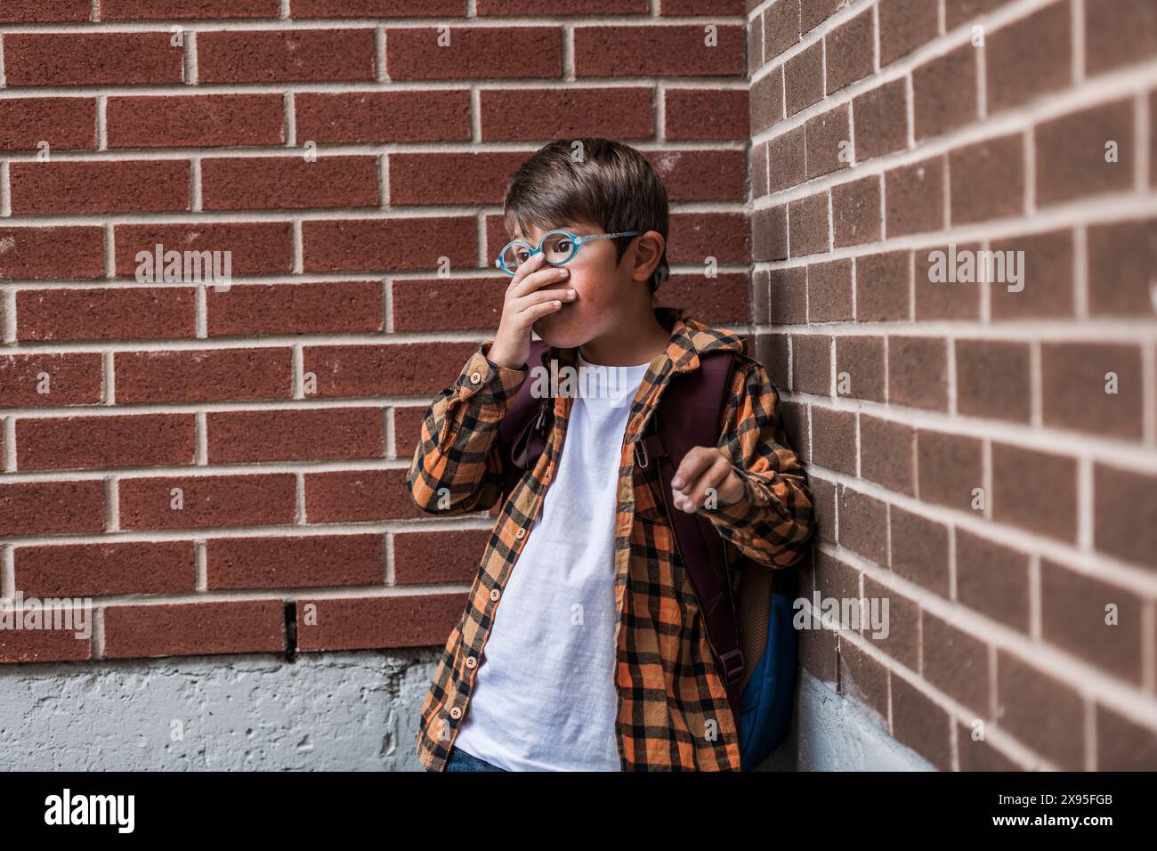 Sad child boy posing on the school playground Stock Photo - Alamy
