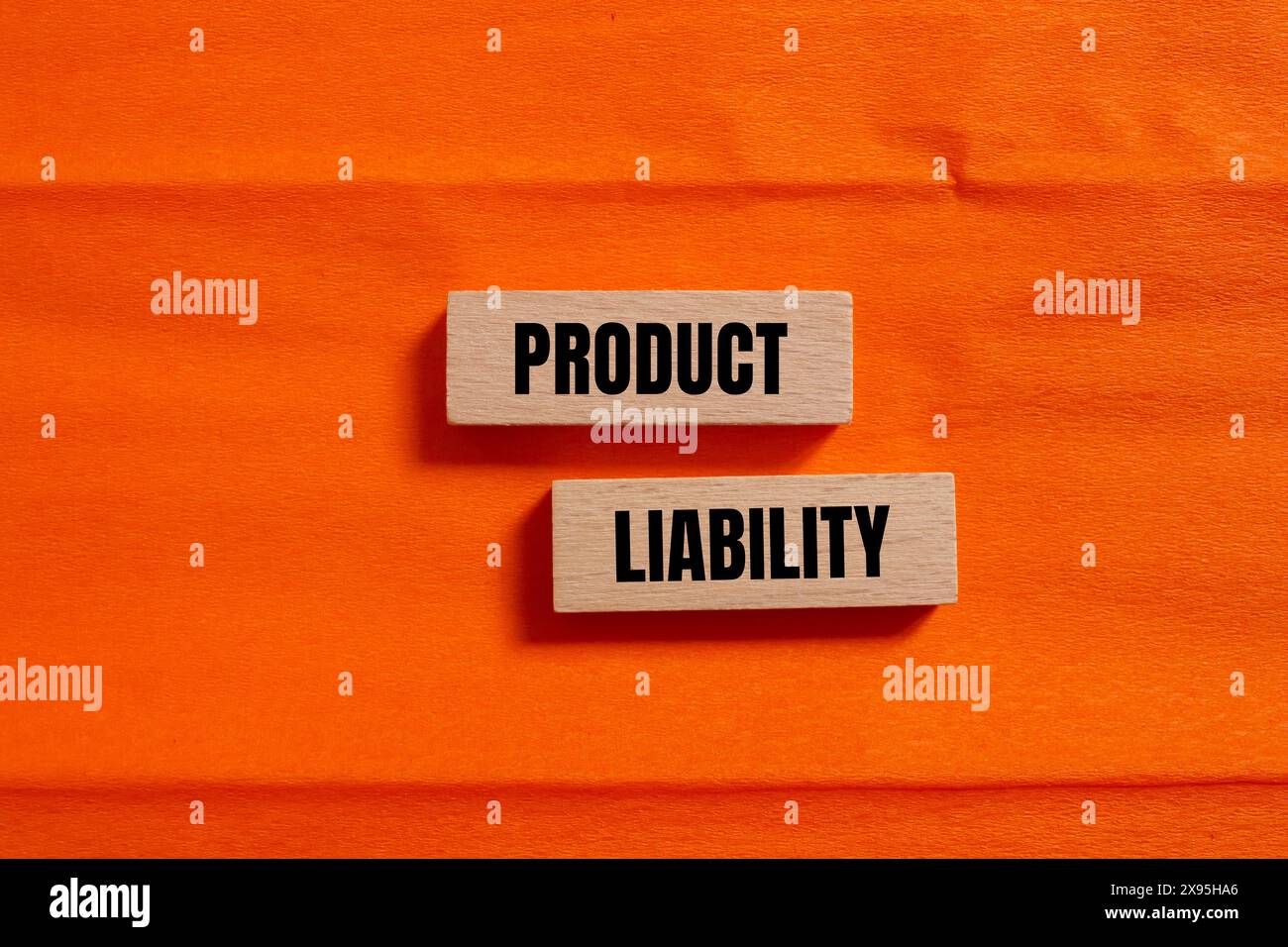 Product liability words written on wooden blocks with orange background ...