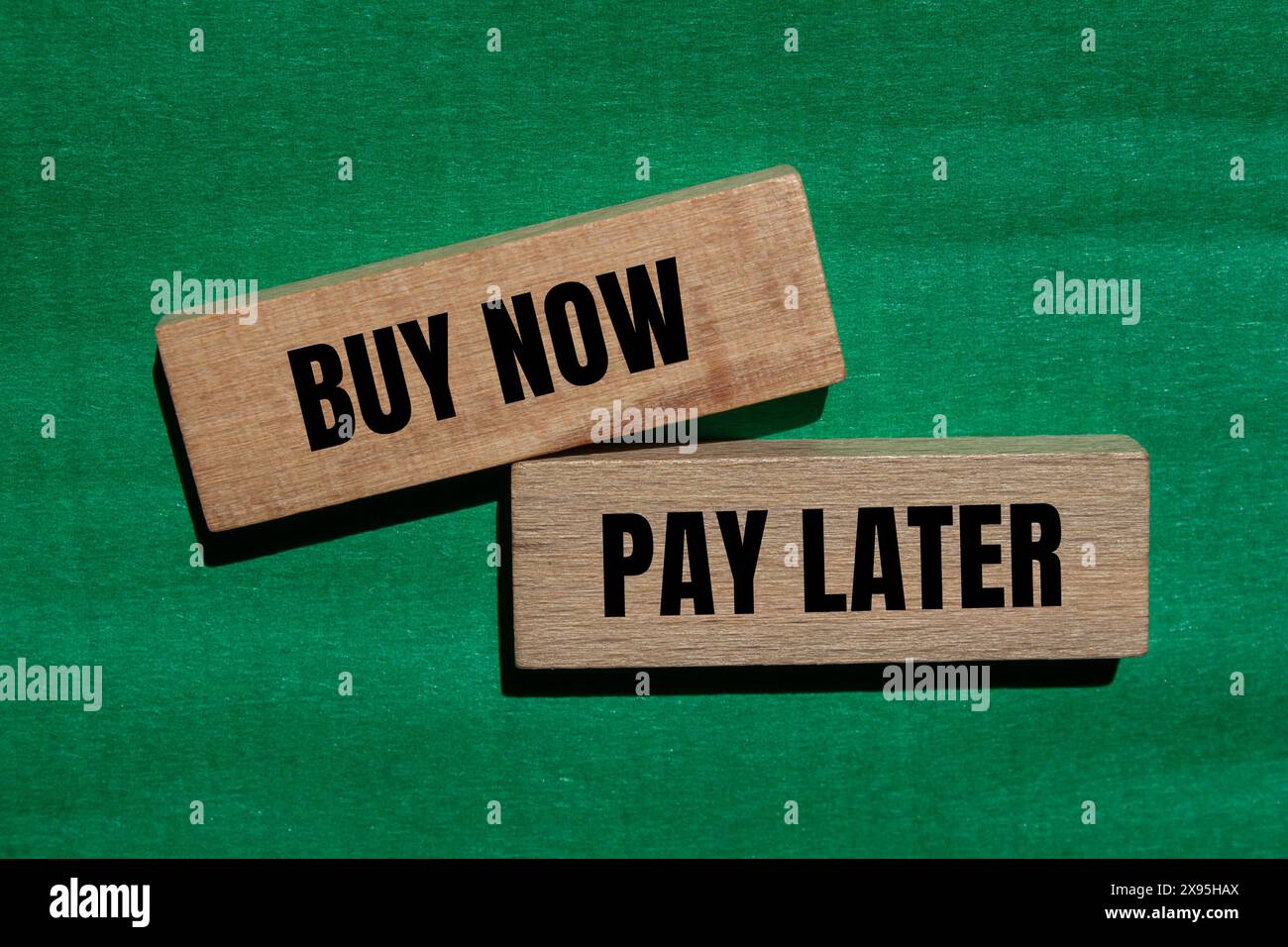 Buy now pay later words written on wooden blocks with green background ...